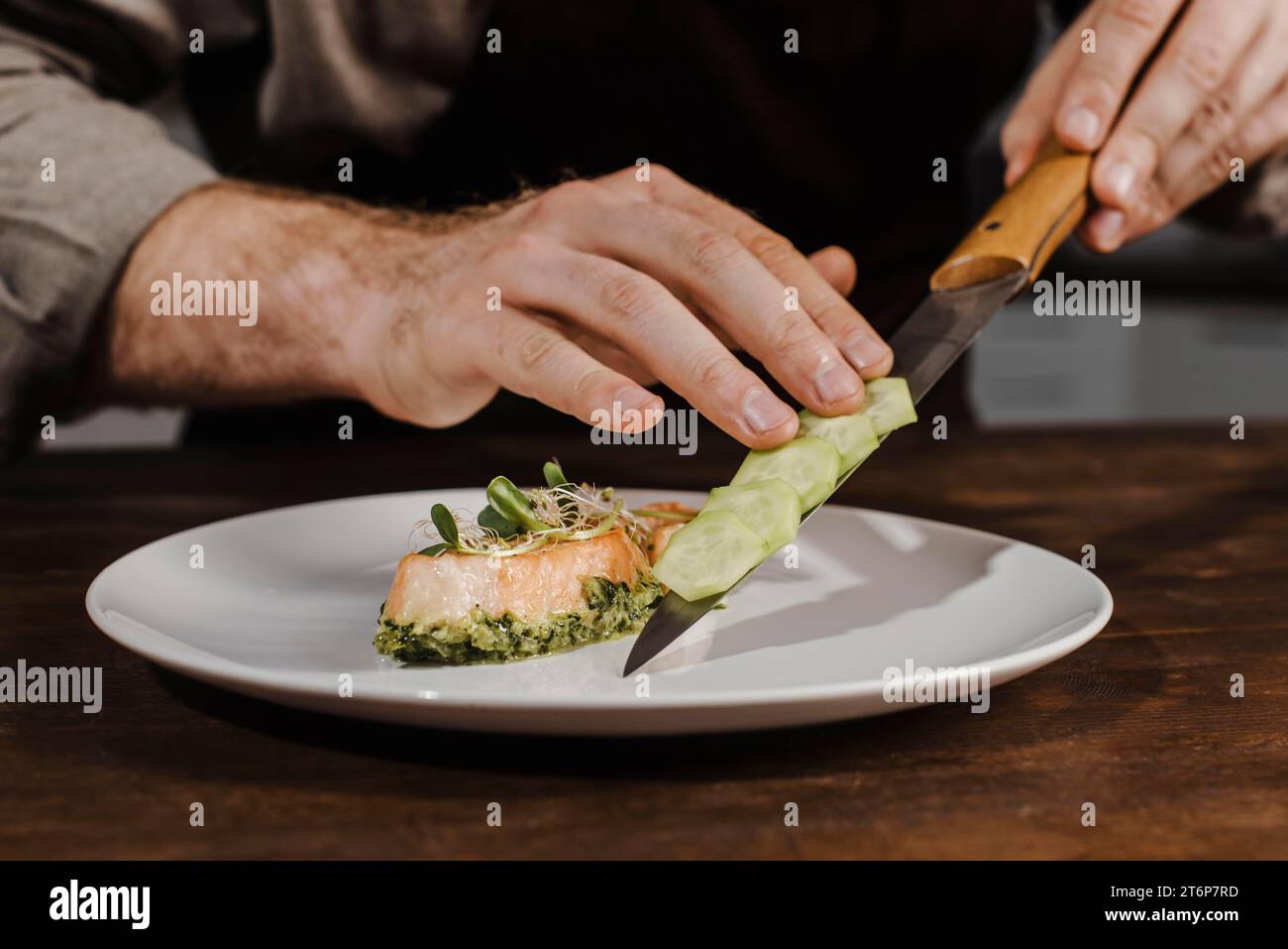 Front view chef plating meal Stock Photo - Alamy