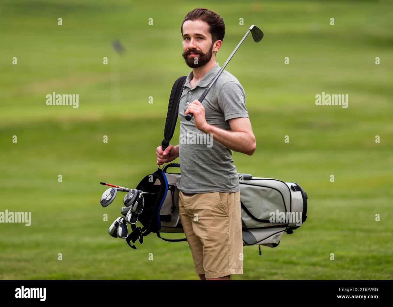 Front view adult man with golf clubs Stock Photo - Alamy
