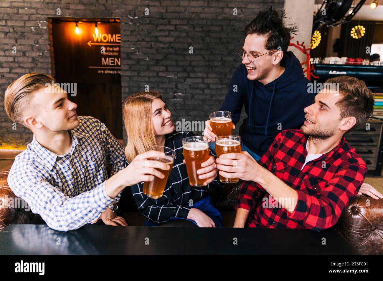 Group friends enjoying beer pub Stock Photo - Alamy