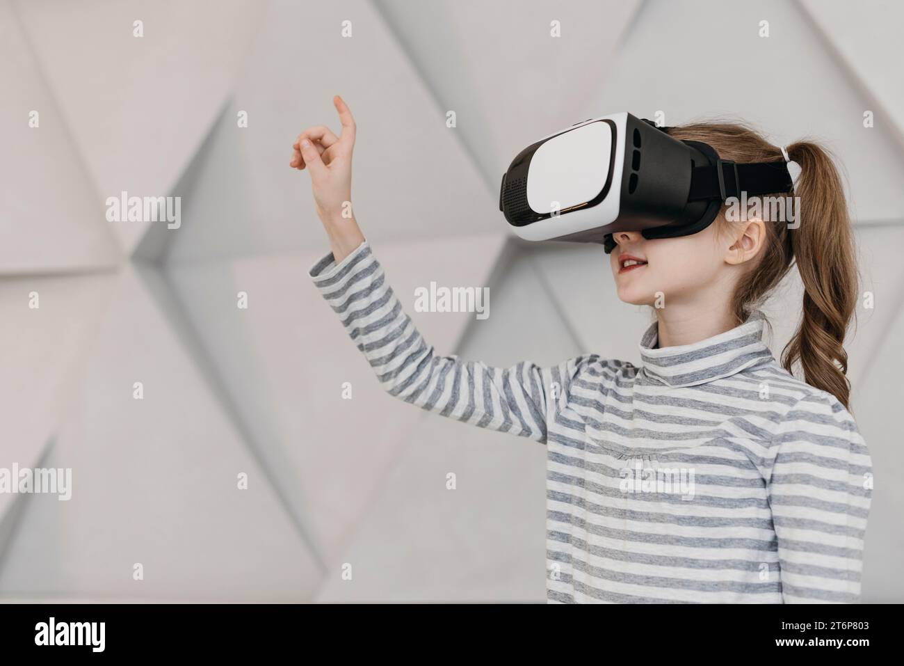 Girl wearing virtual reality headset holding hand air Stock Photo - Alamy