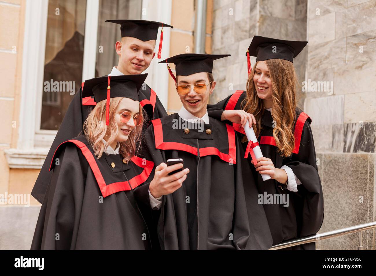 Happy students graduating Stock Photo - Alamy