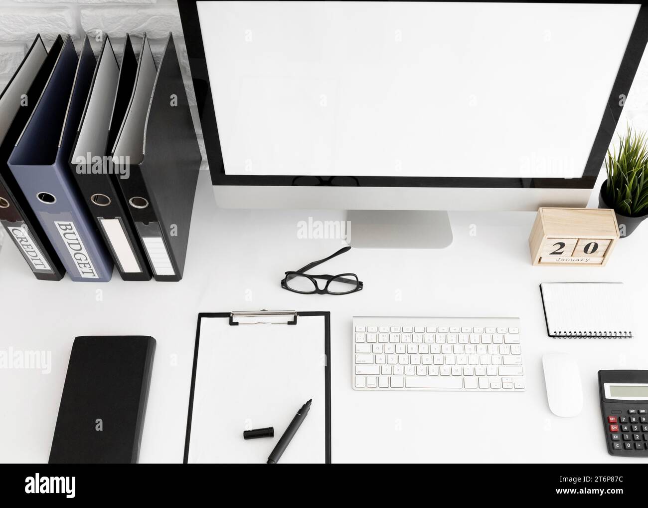 High angle office desk with computer screen clipboard Stock Photo - Alamy