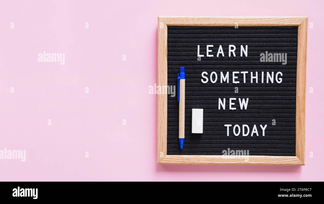 Learn something new today text slate with pen eraser pink background ...