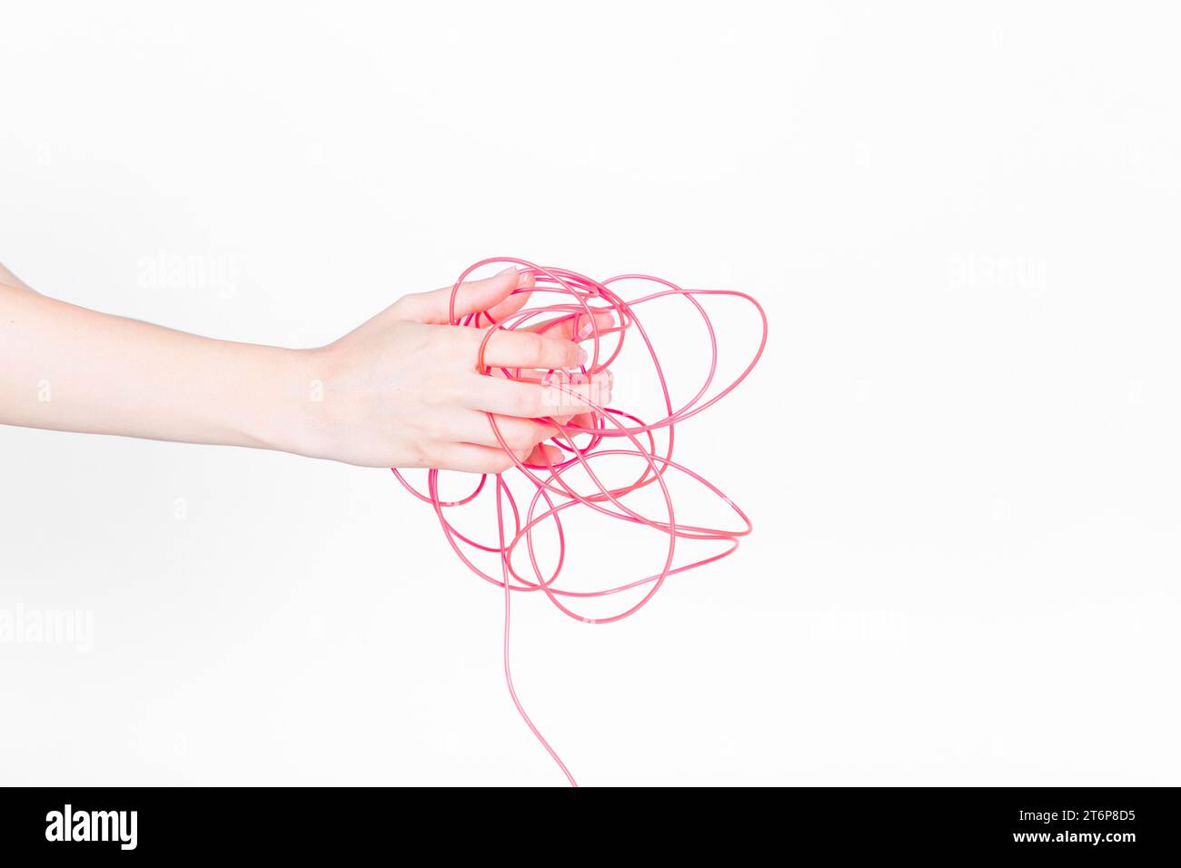 Human hand with tangled red wire Stock Photo - Alamy