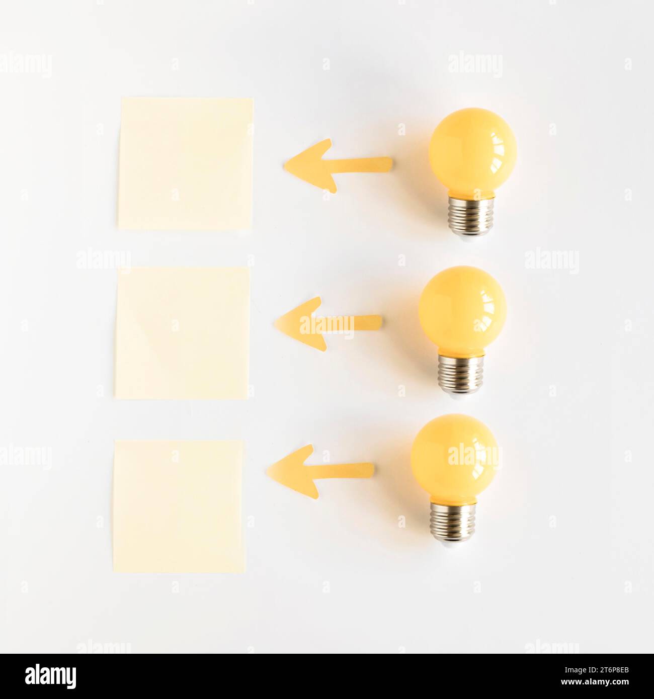 Light bulb near arrow symbols showing direction towards adhesive notes ...