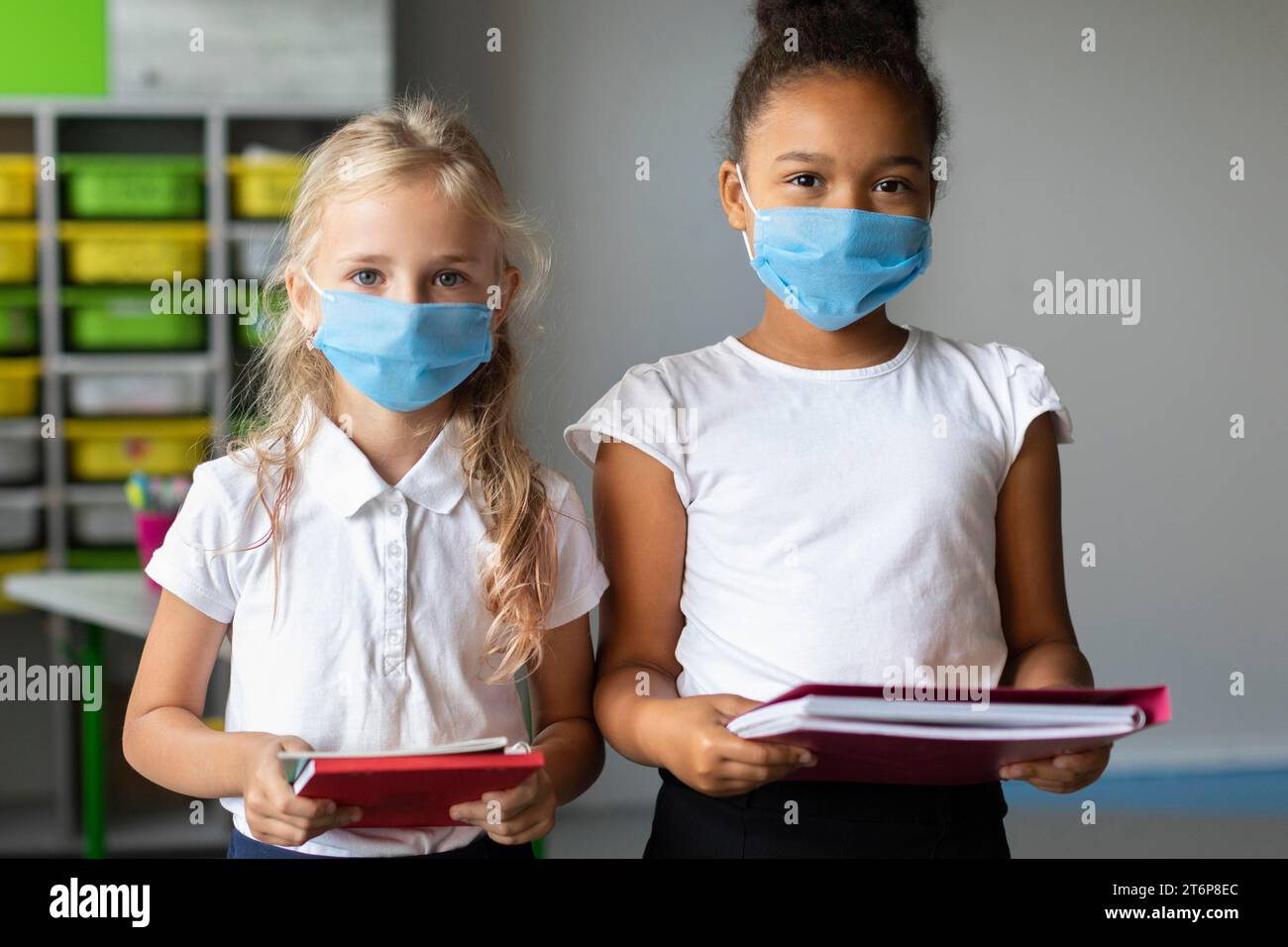 Little girls wearing medical masks class Stock Photo - Alamy