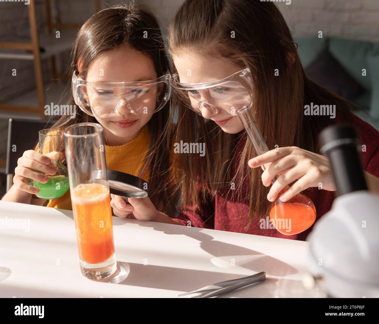 Medium shot girls holding flasks Stock Photo - Alamy