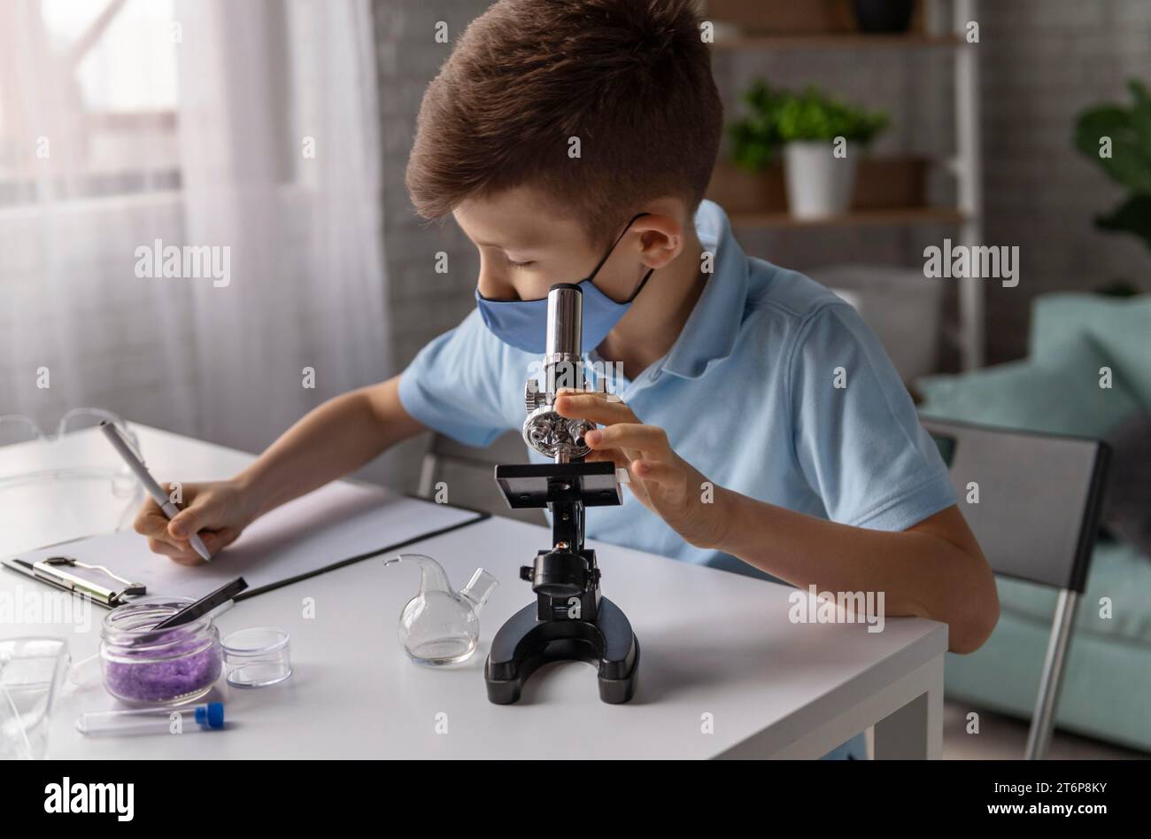 Medium shot kid learning with microscope Stock Photo - Alamy