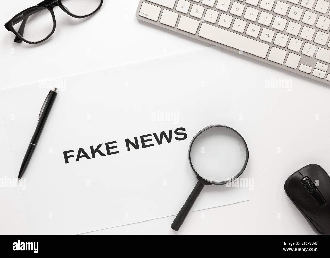 Paper sheet with fake news message Stock Photo - Alamy