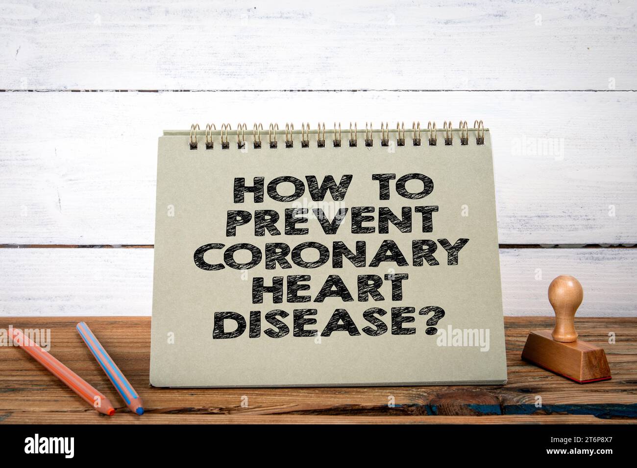 How to Prevent Coronary Heart Disease. Green notepad on wooden texture ...