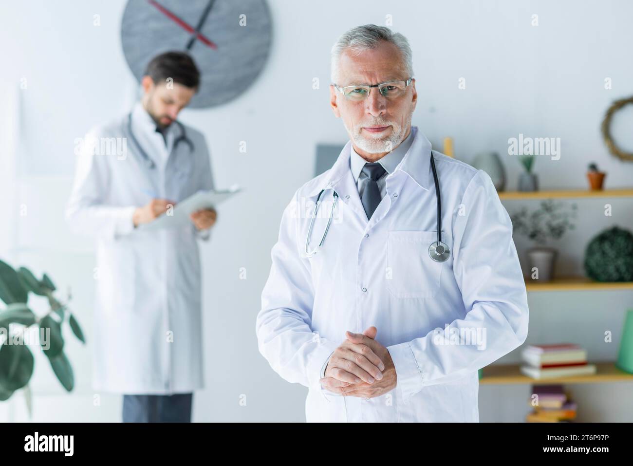 Positive senior doctor office Stock Photo - Alamy