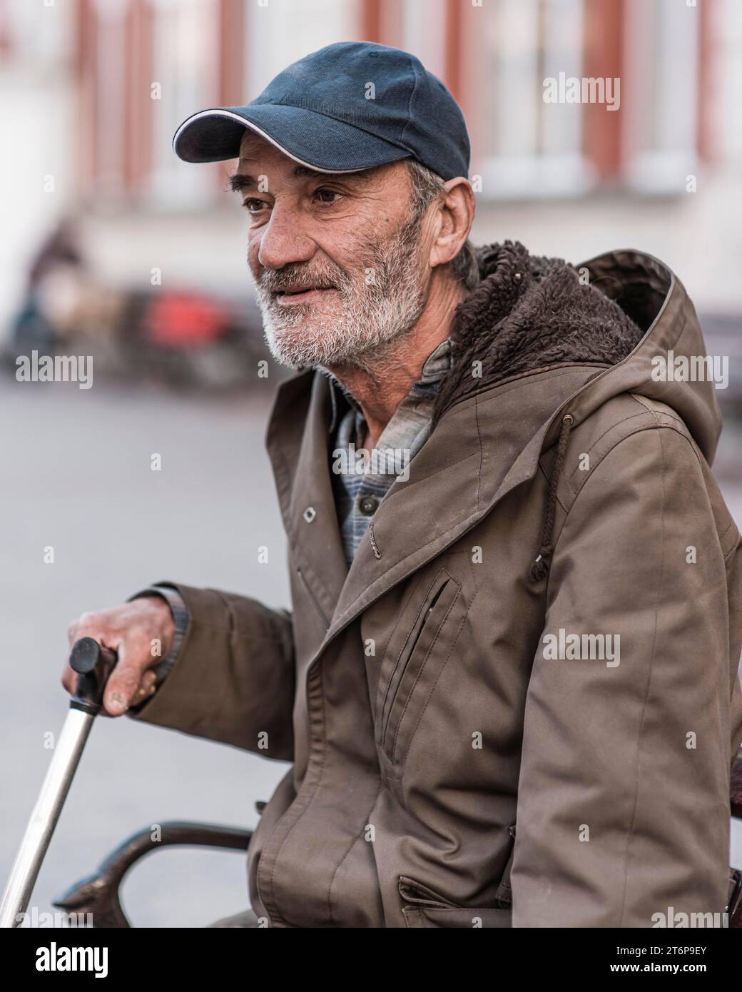 Side view homeless man outdoors with cane Stock Photo - Alamy