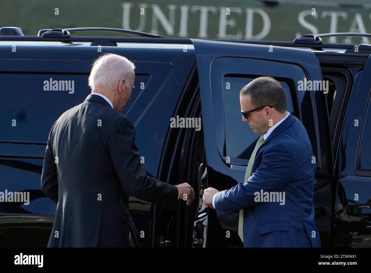 President Joe Biden board his motorcade vehicle after arriving on ...