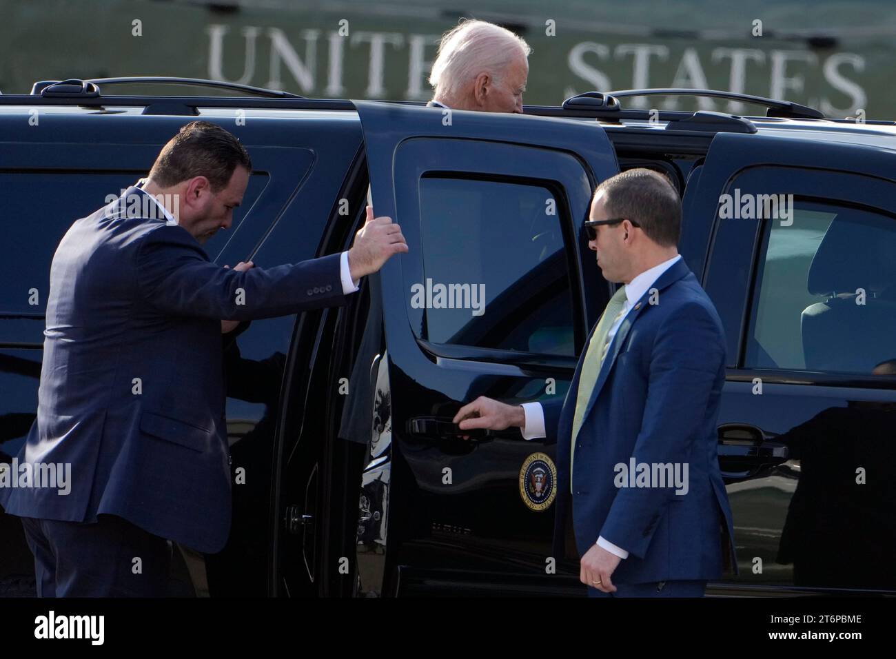 President Joe Biden board his motorcade vehicle after arriving on ...