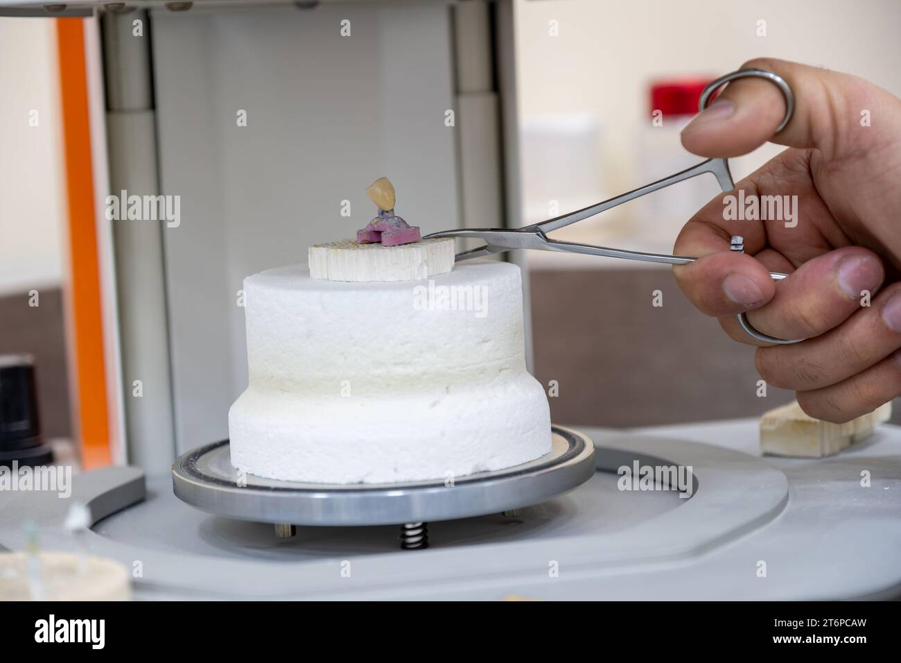 Technician operates high temperature furnace to bake prosthetic ceramic ...
