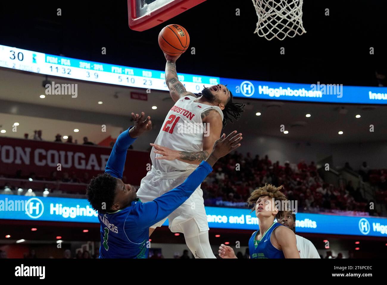 Houston's Emanuel Sharp (21) goes up for a shot as Texas A&M-Corpus ...