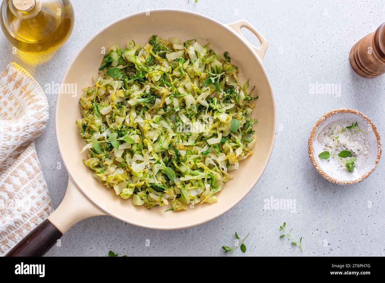 Sauteed cabbage with herbs in a cast iron pan, healthy vegetable side ...