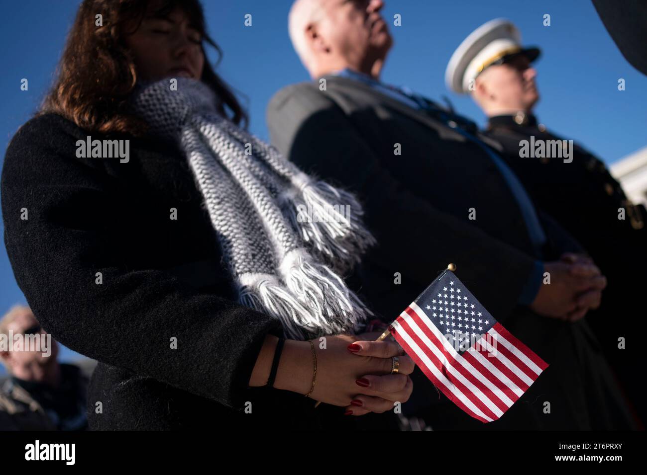 Attendees pray during a a National Veterans Day Observance ceremony at ...