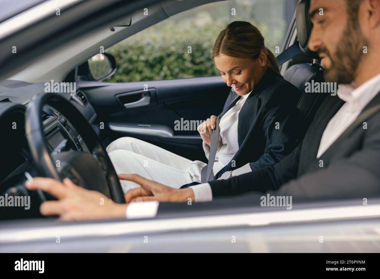 Cheerful couple of business colleagues going on a business trip ...