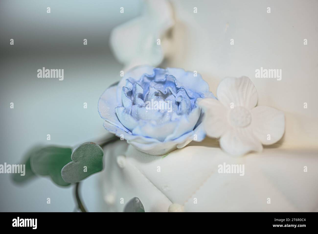 Gorgeous white wedding cake close up with blue and white fondant ...
