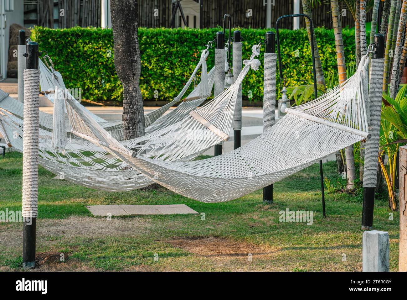 Beautiful white hammocks hanging on open air tropical hotel Stock Photo - Alamy