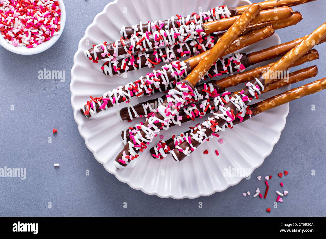 Chocolate dipped pretzel rods with dark and white chocolate and pink ...