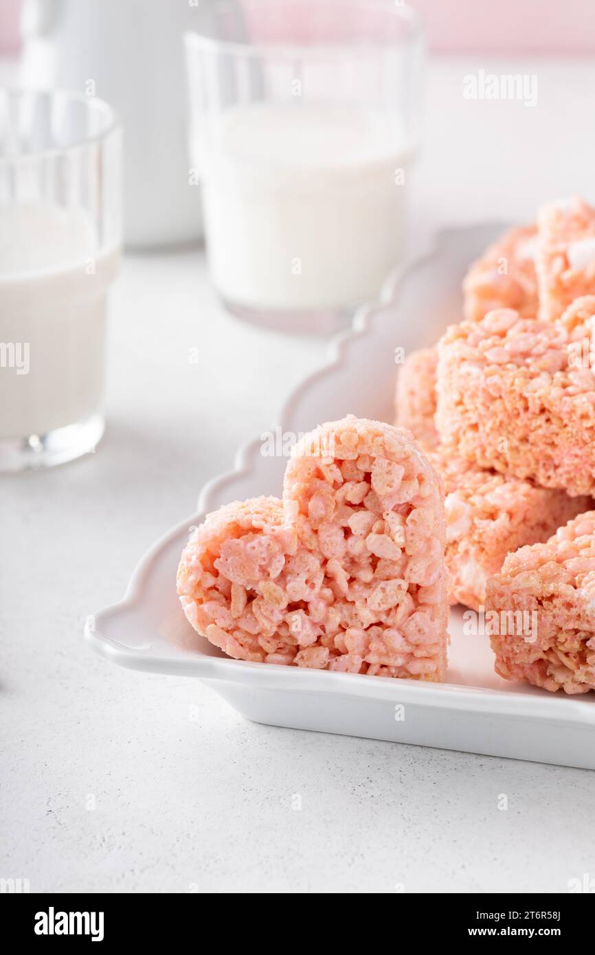 Pink heart shaped rice krispie treats served with milk, homemade sweet ...
