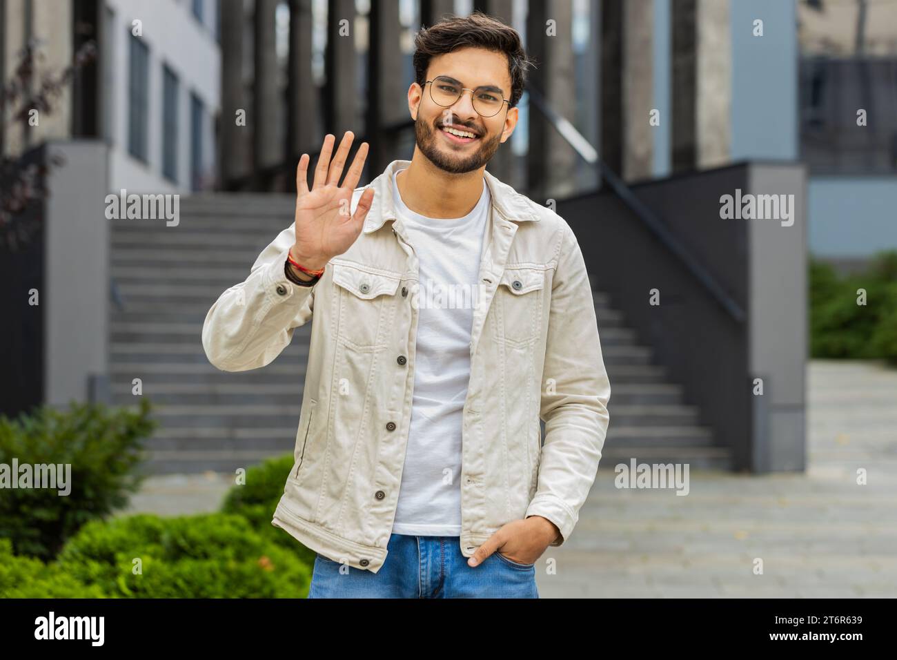 Happy indian man gesturing hi hi-res stock photography and images - Alamy