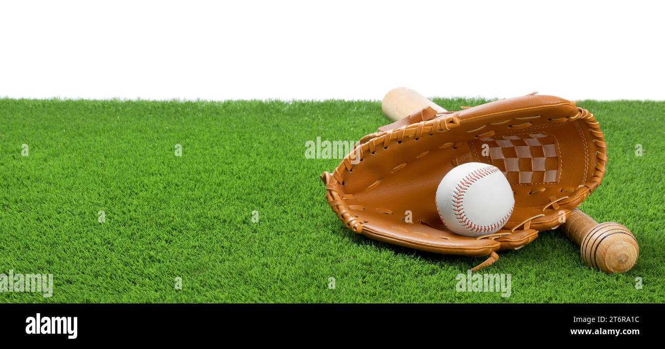 Baseball bat, ball and catcher's mitt on artificial grass against white ...