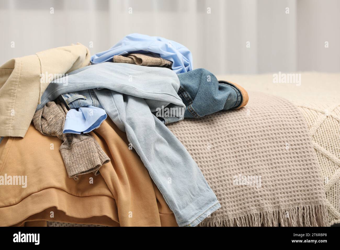 Pile clothes on bed hi-res stock photography and images - Alamy