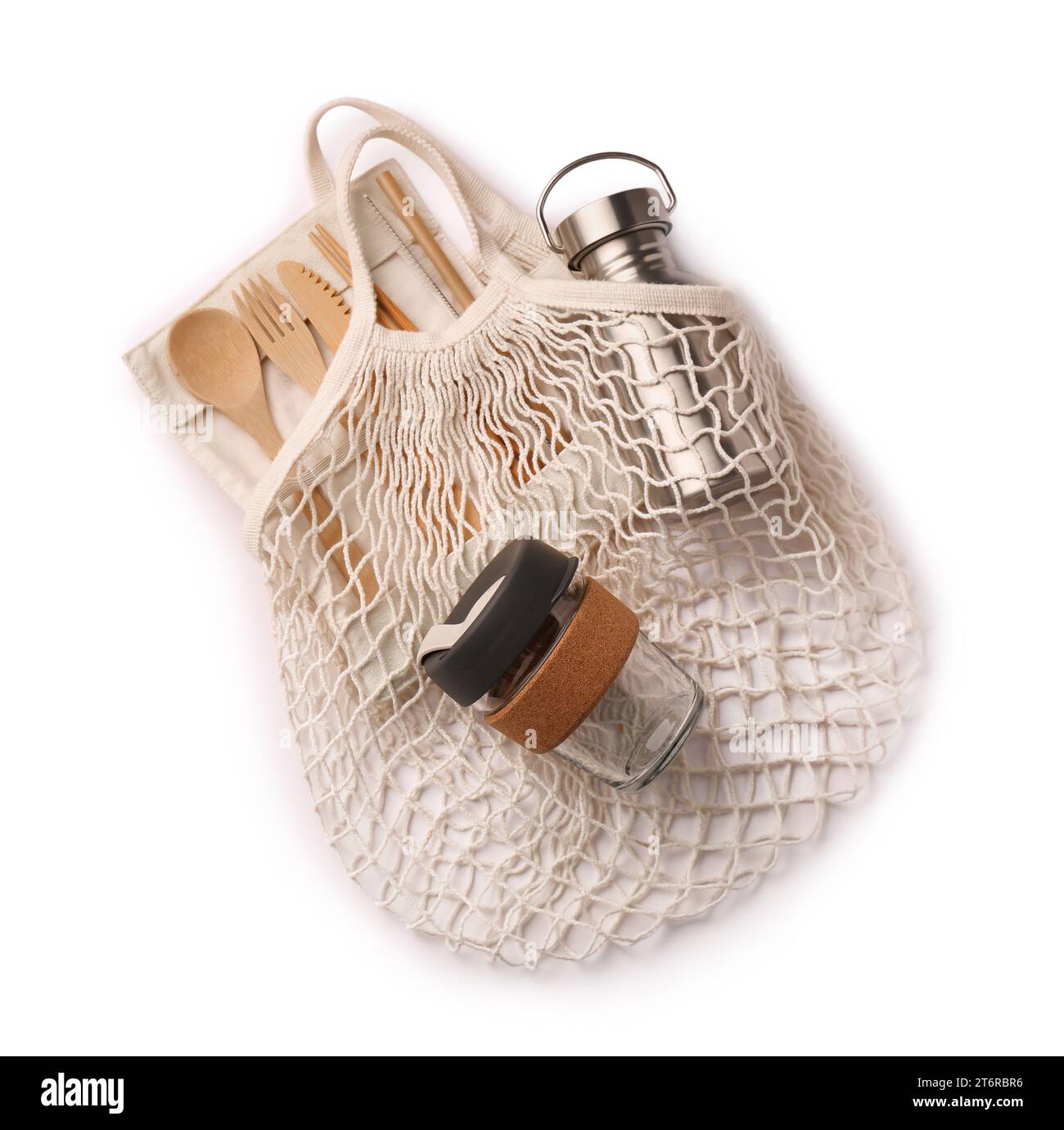 Fishnet bag with different items isolated on white, top view. Conscious ...