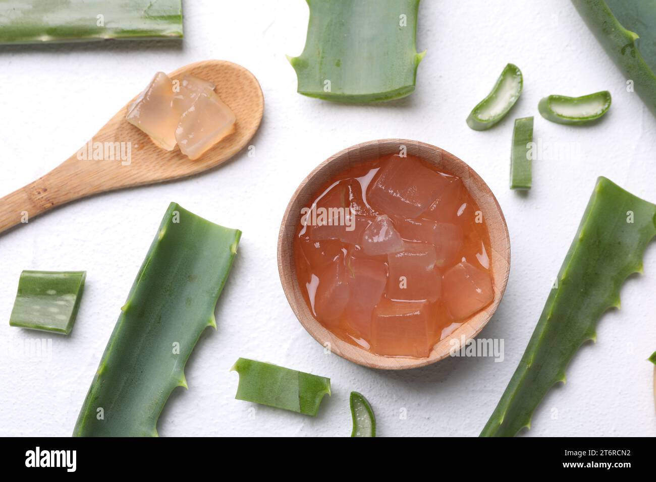 Flat lay composition with aloe vera gel and slices of plant on white ...