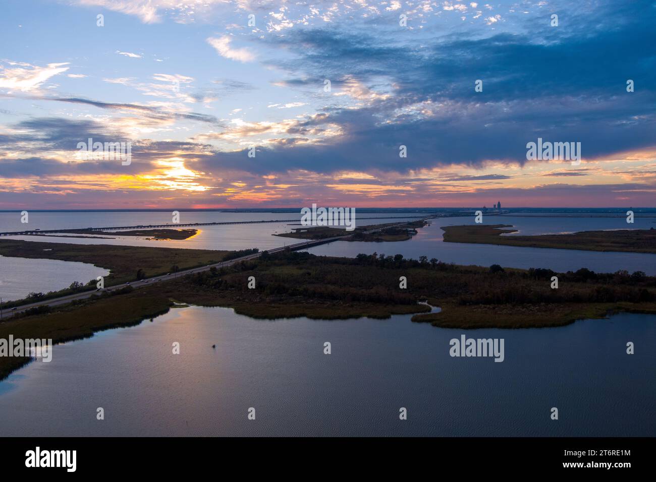 Aerial view of the Mobile Bay causeway and the Jubilee Parkway bridge at sunset on the Alabama ...