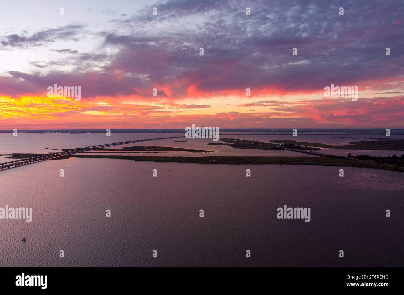 Aerial view of the Mobile Bay causeway and the Jubilee Parkway bridge at sunset on the Alabama ...