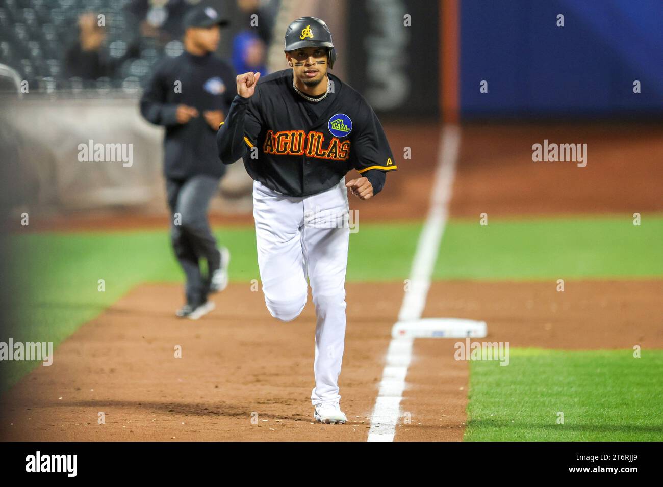 Las Águilas Cibaeñas Christopher Morel (95) scores on a sacrifice fly ...