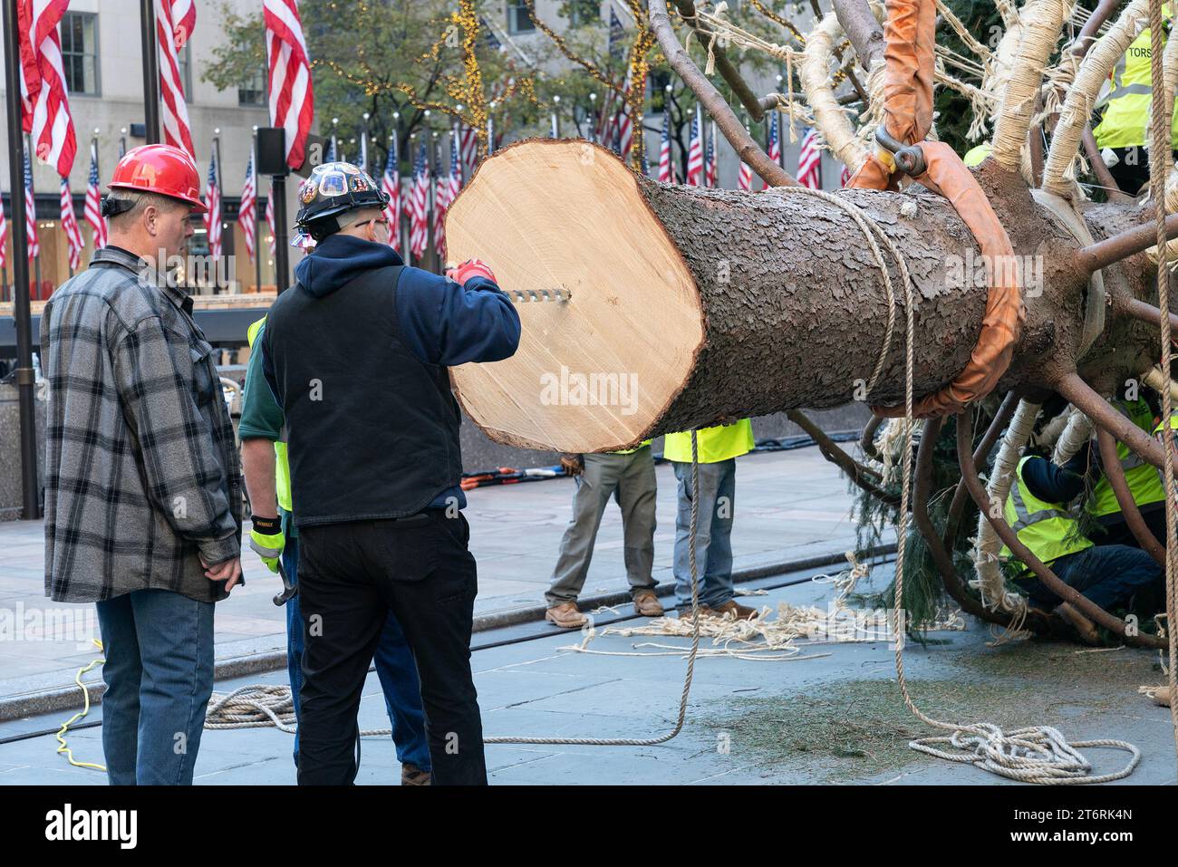 Workers drill to install spike into The Rockefeller Center Christmas ...