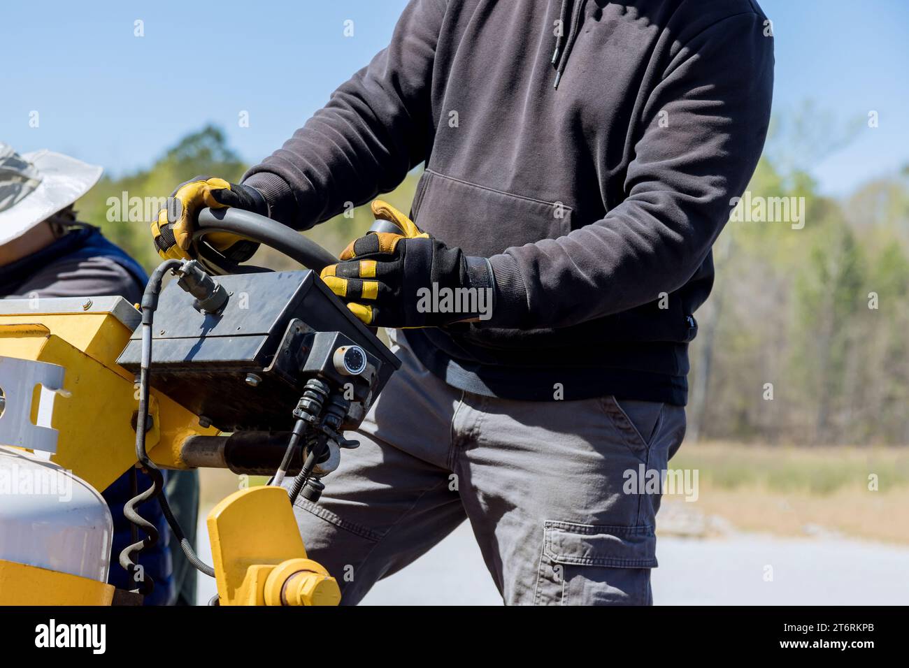 During highway construction, pavement machine lays fresh bitumen ...