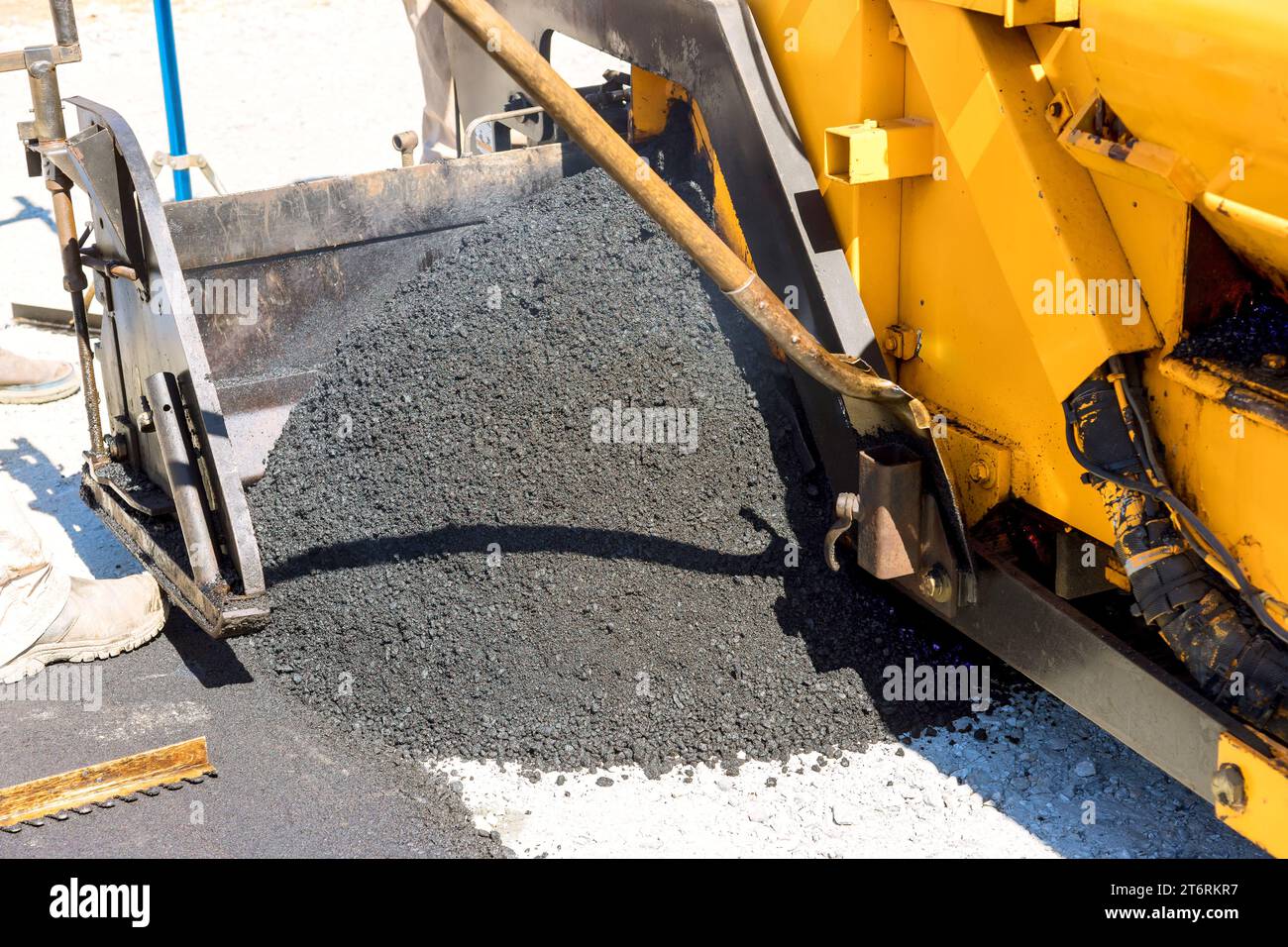 As part of highway construction pavement machine is laying asphalt on ...