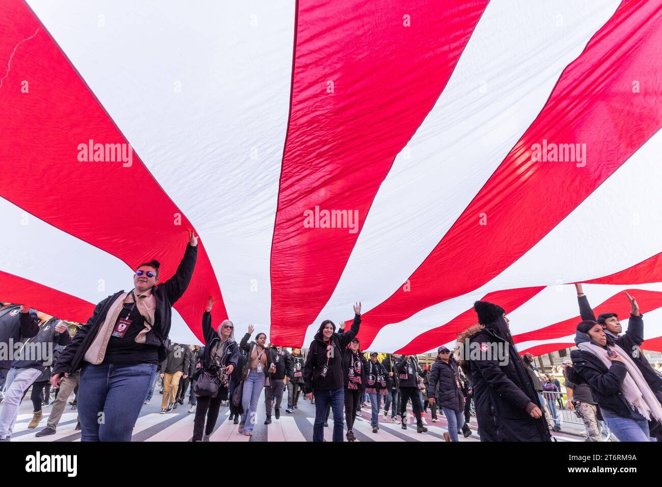 Members of Wounded Wariors Project march with huge American Flag during ...