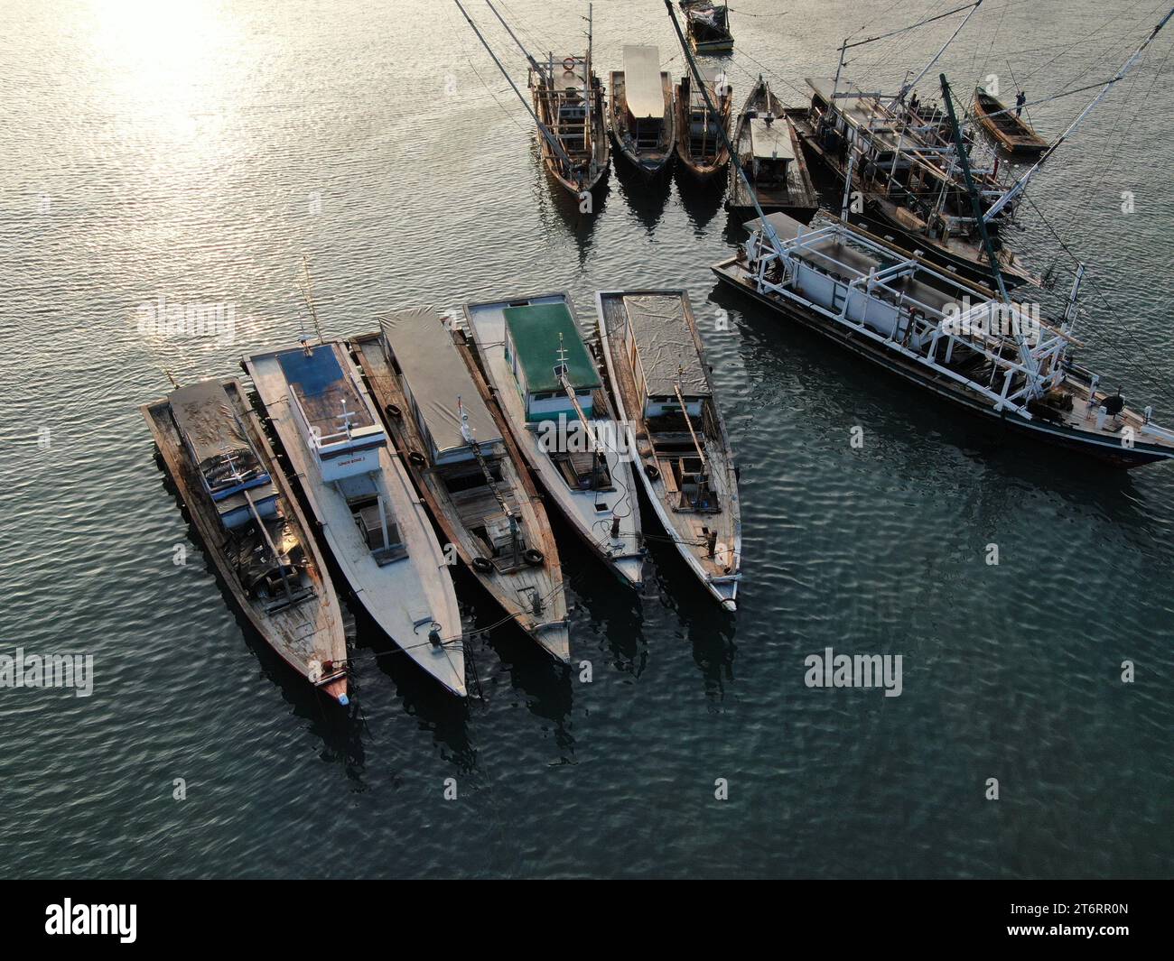 Fishing boats moored in the shallow waters Sumur beach of Banten ...
