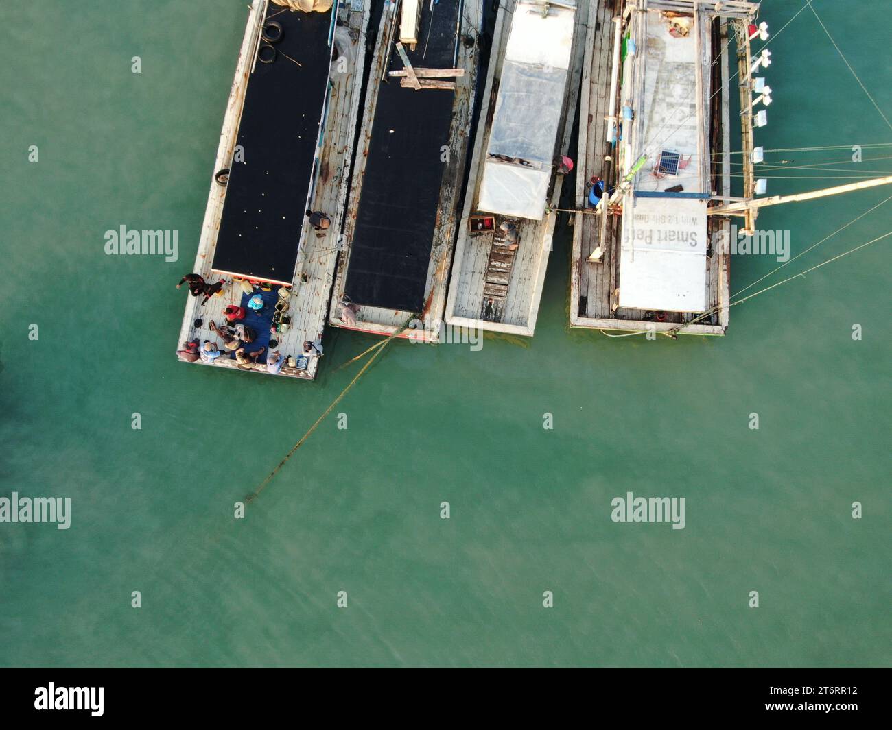 Fishing boats moored in the shallow waters Sumur beach of Banten ...