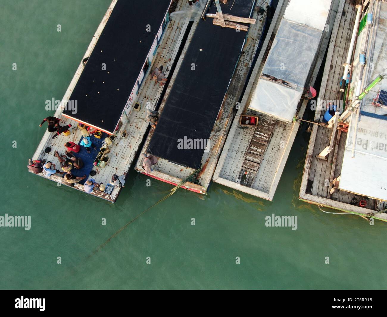 Fishing boats moored in the shallow waters Sumur beach of Banten ...