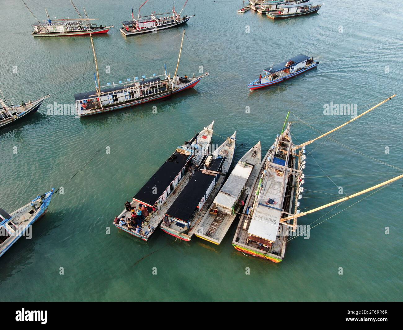 Fishing boats moored in the shallow waters Sumur beach of Banten ...