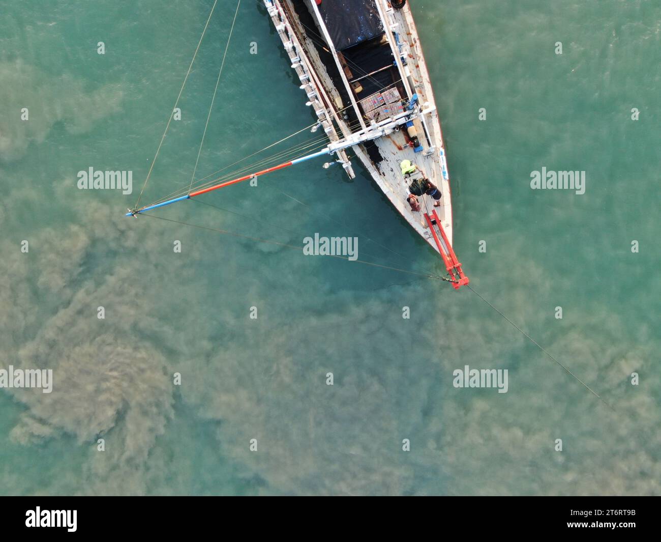 Fishing boats moored in the shallow waters at Sumur Pandeglang of ...