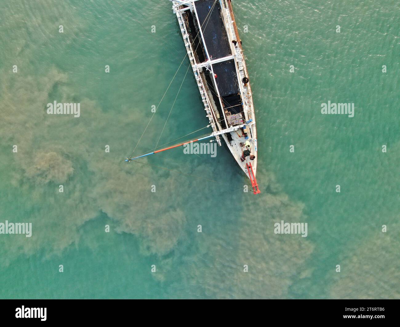 Fishing boats moored in the shallow waters at Sumur Pandeglang of ...