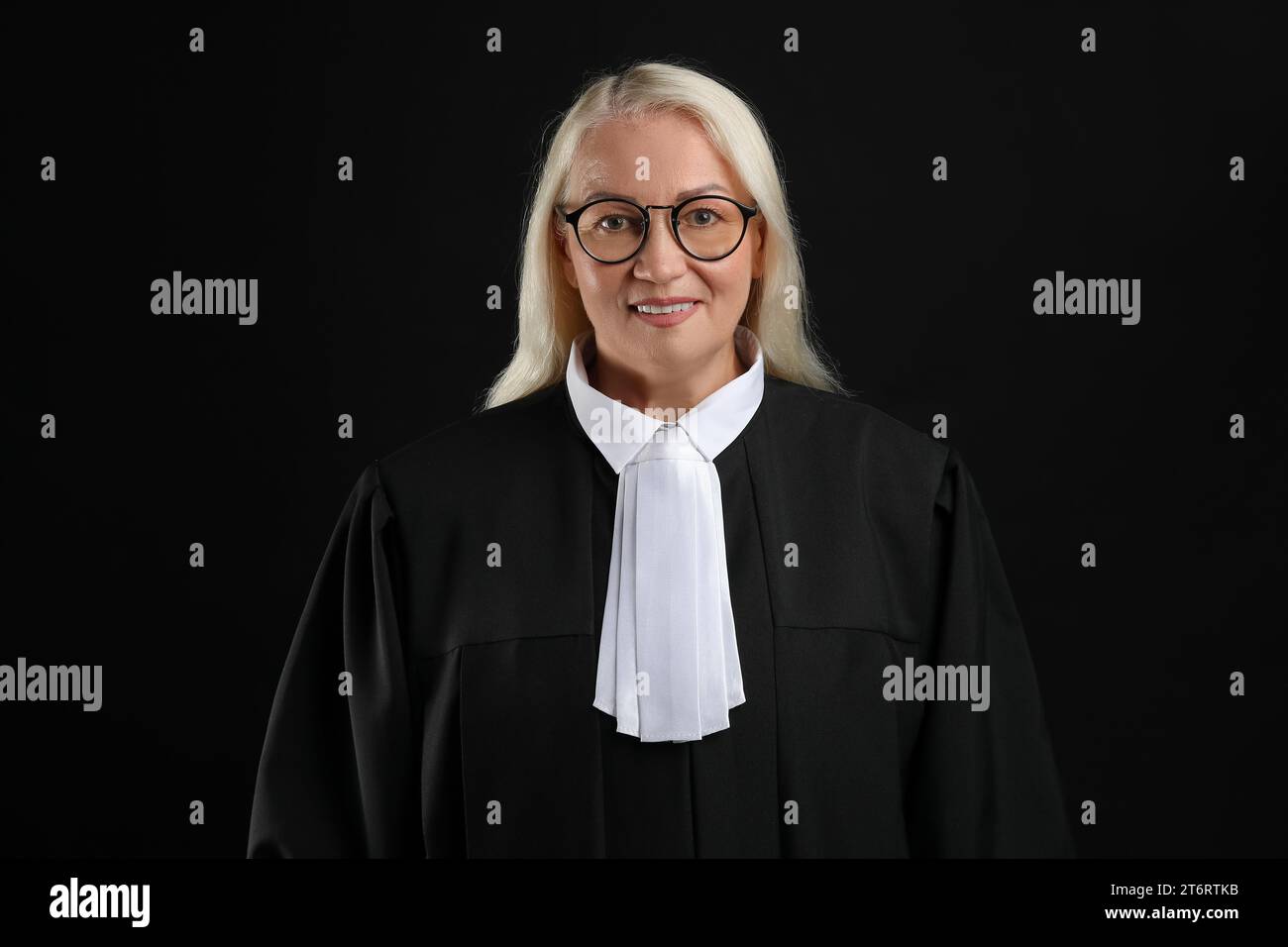 Mature female judge on black background Stock Photo - Alamy