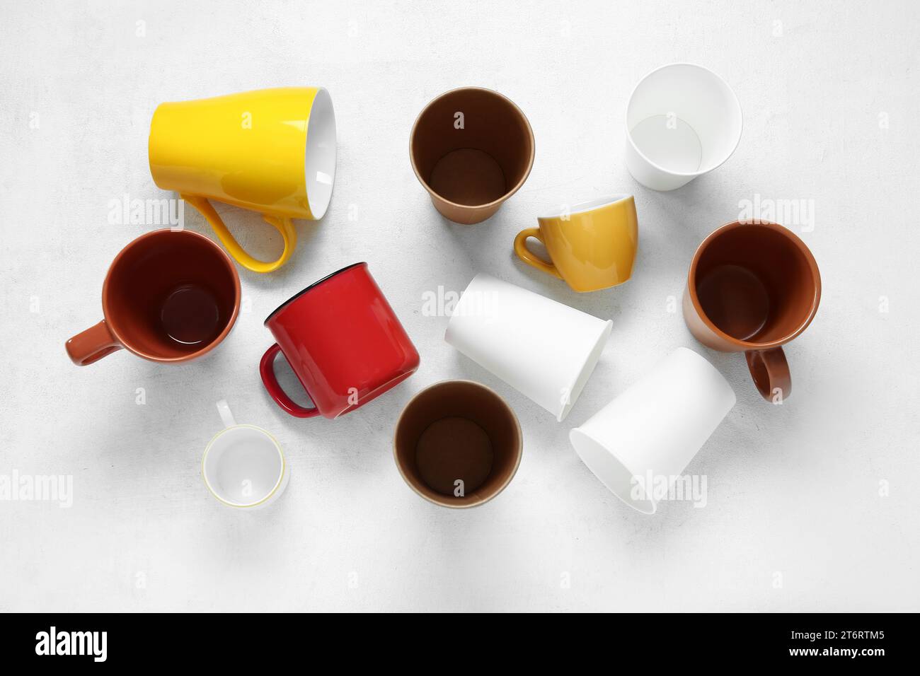 Different cups on white background Stock Photo - Alamy