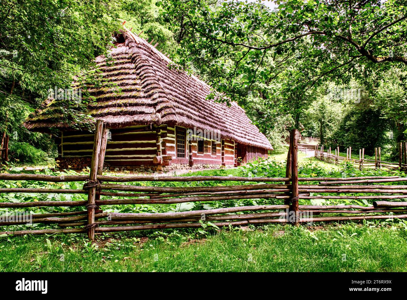 A fragment of a traditional Polish house with a thatched roof and a ...