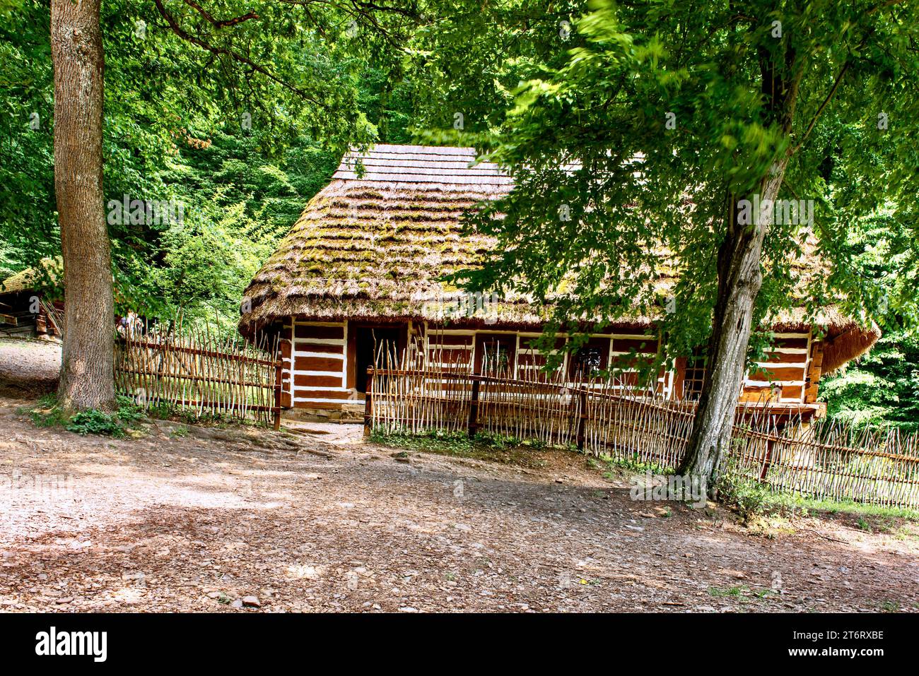 A fragment of a traditional Polish house with a thatched roof and a ...