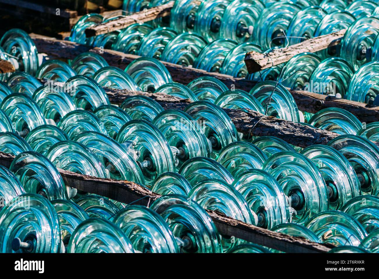 Glass transparent high-voltage insulator is in storage. Industrial ...